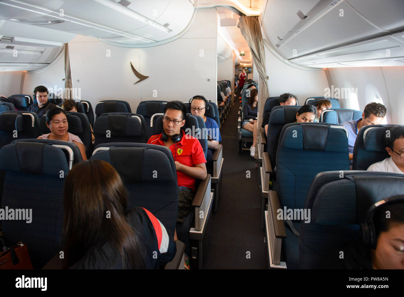 Inside the premium economy class in flight Stock Photo - Alamy