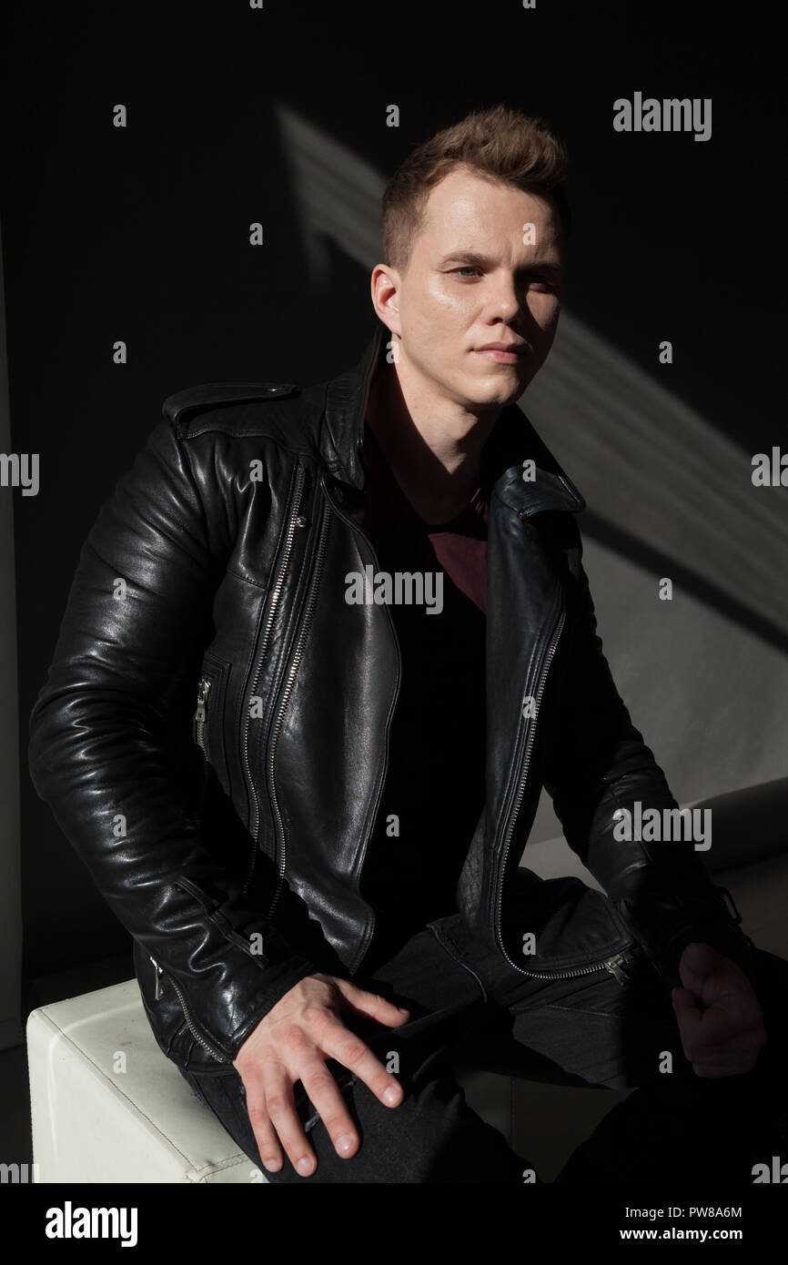 fashion portrait of a man in black fancy leather jacket Stock Photo - Alamy
