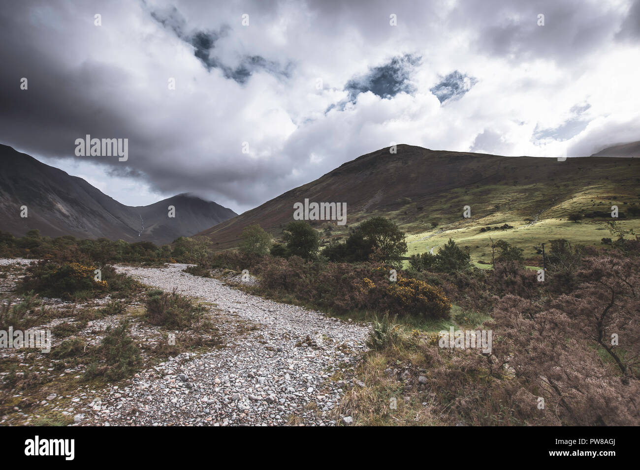 Dramatic sky over scenic valley with low rain clouds touching mountain ...
