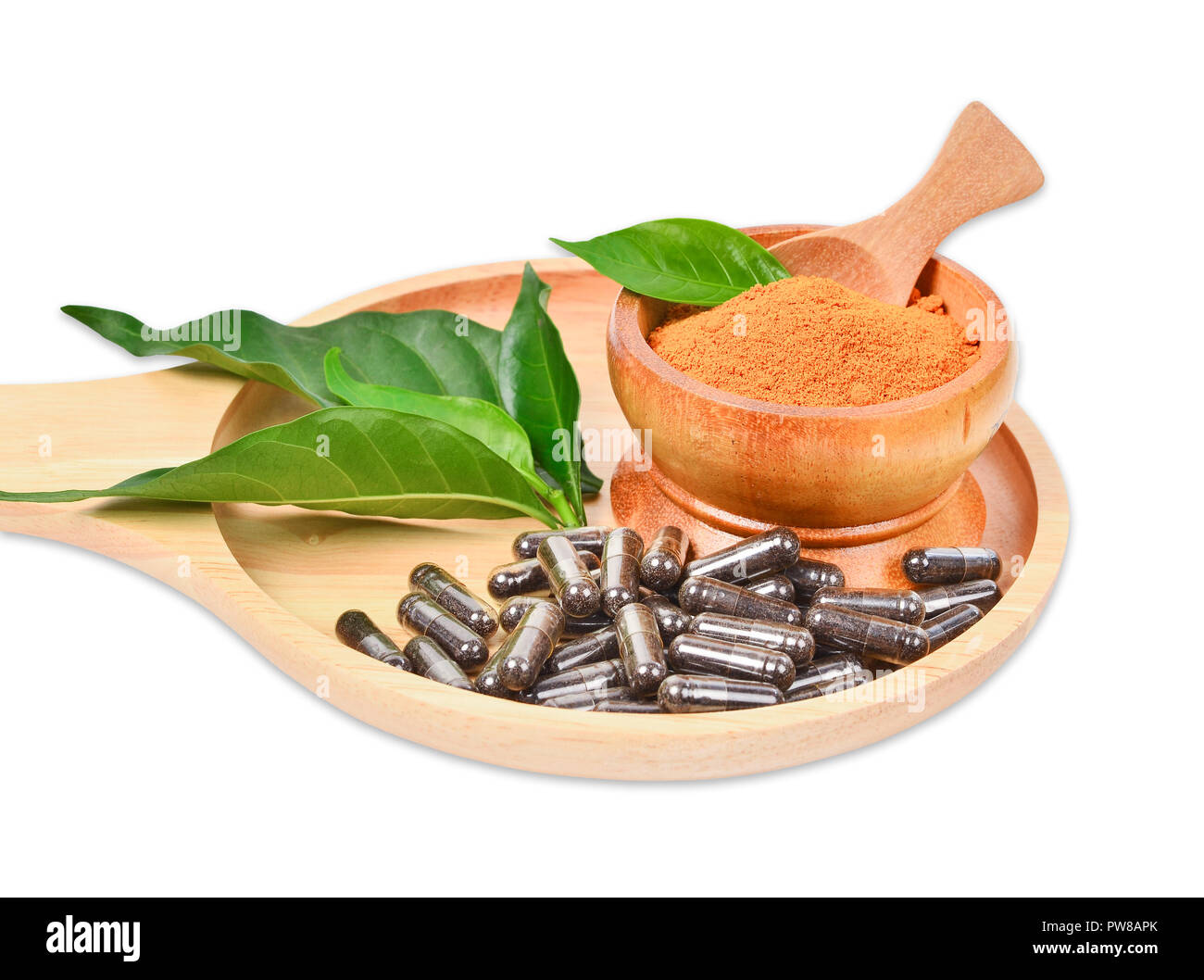 Natural medicine capsule pill with black herb, and wooden mortar on ...