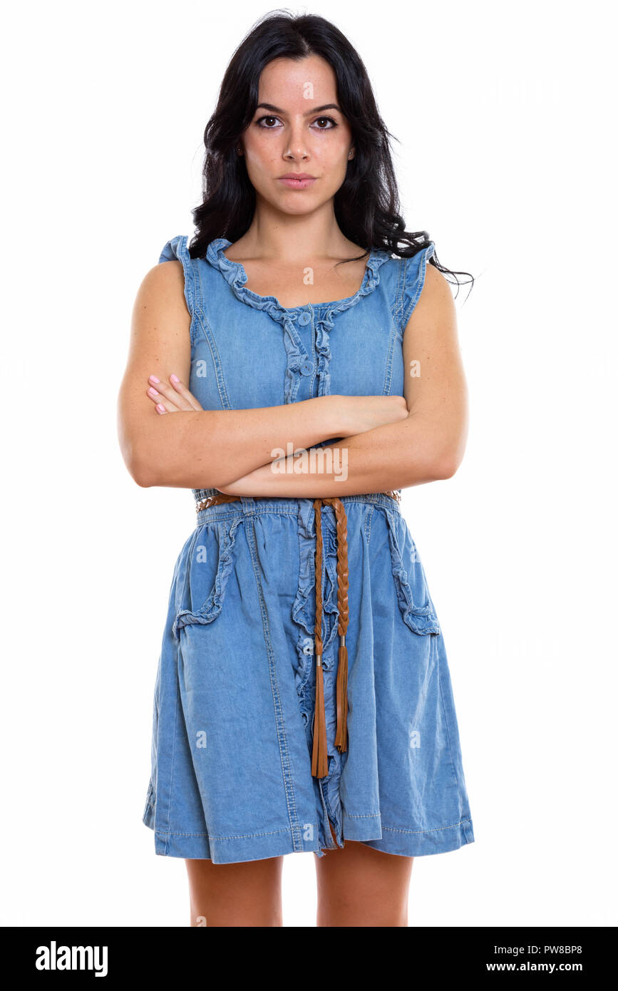 Studio shot of young beautiful Spanish woman standing with arms Stock ...