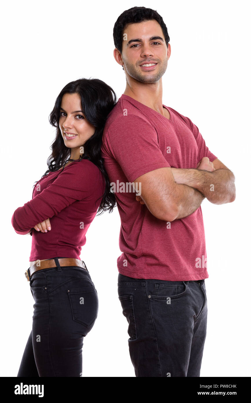 Studio shot of young happy couple smiling with arms crossed toge Stock ...