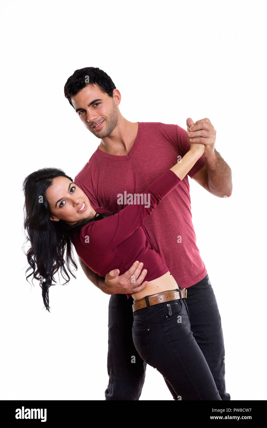 Studio shot of young happy couple smiling while dancing together Stock ...