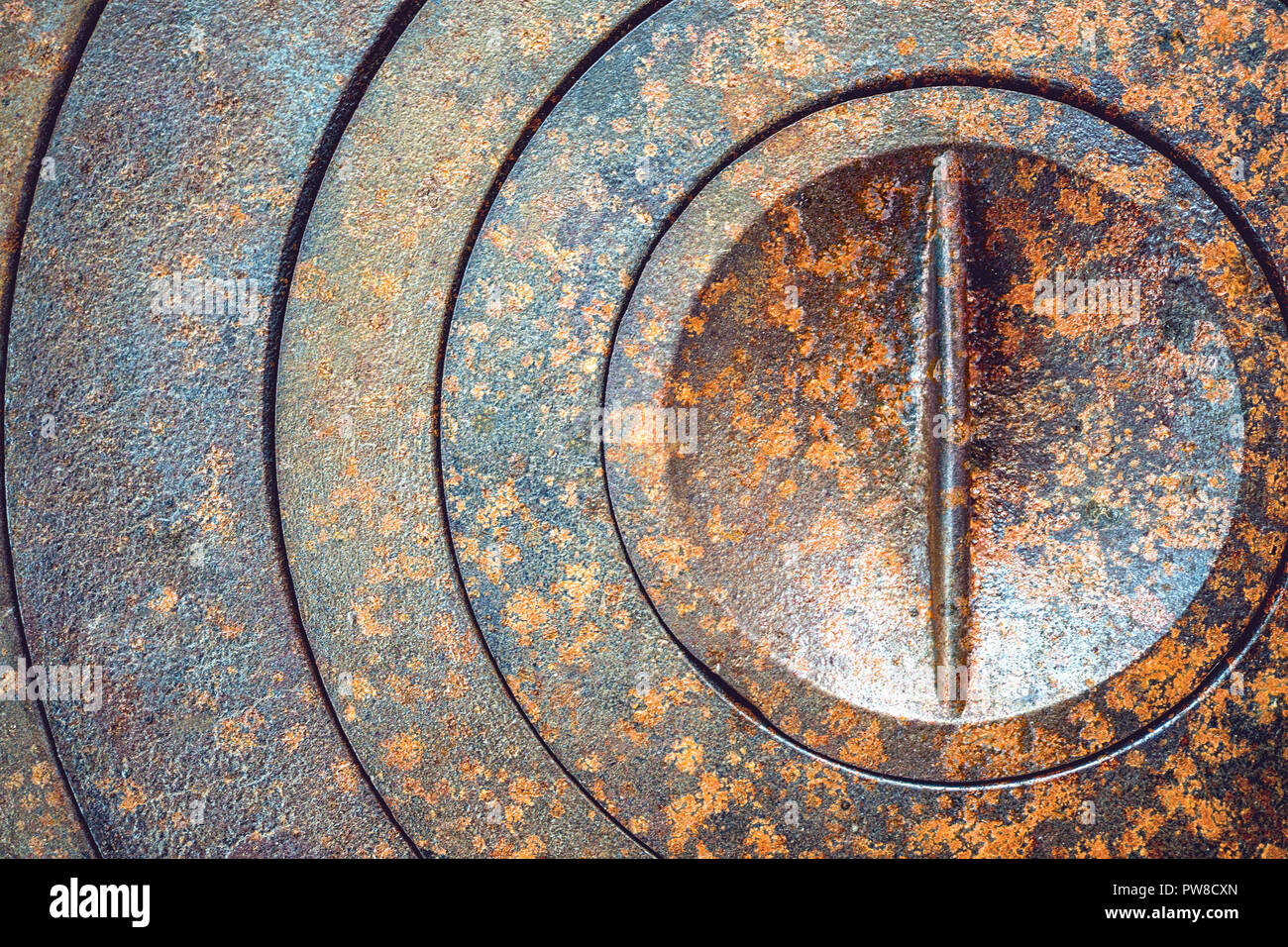 Abstract metal background with geometric holes in a circle and rust ...