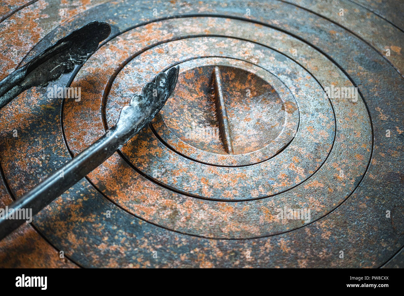 Abstract metal background with geometric holes in a circle and rust ...