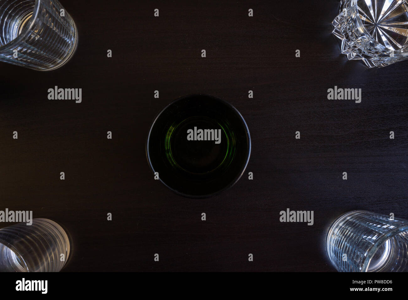 A black wooden background with five glasses Stock Photo - Alamy