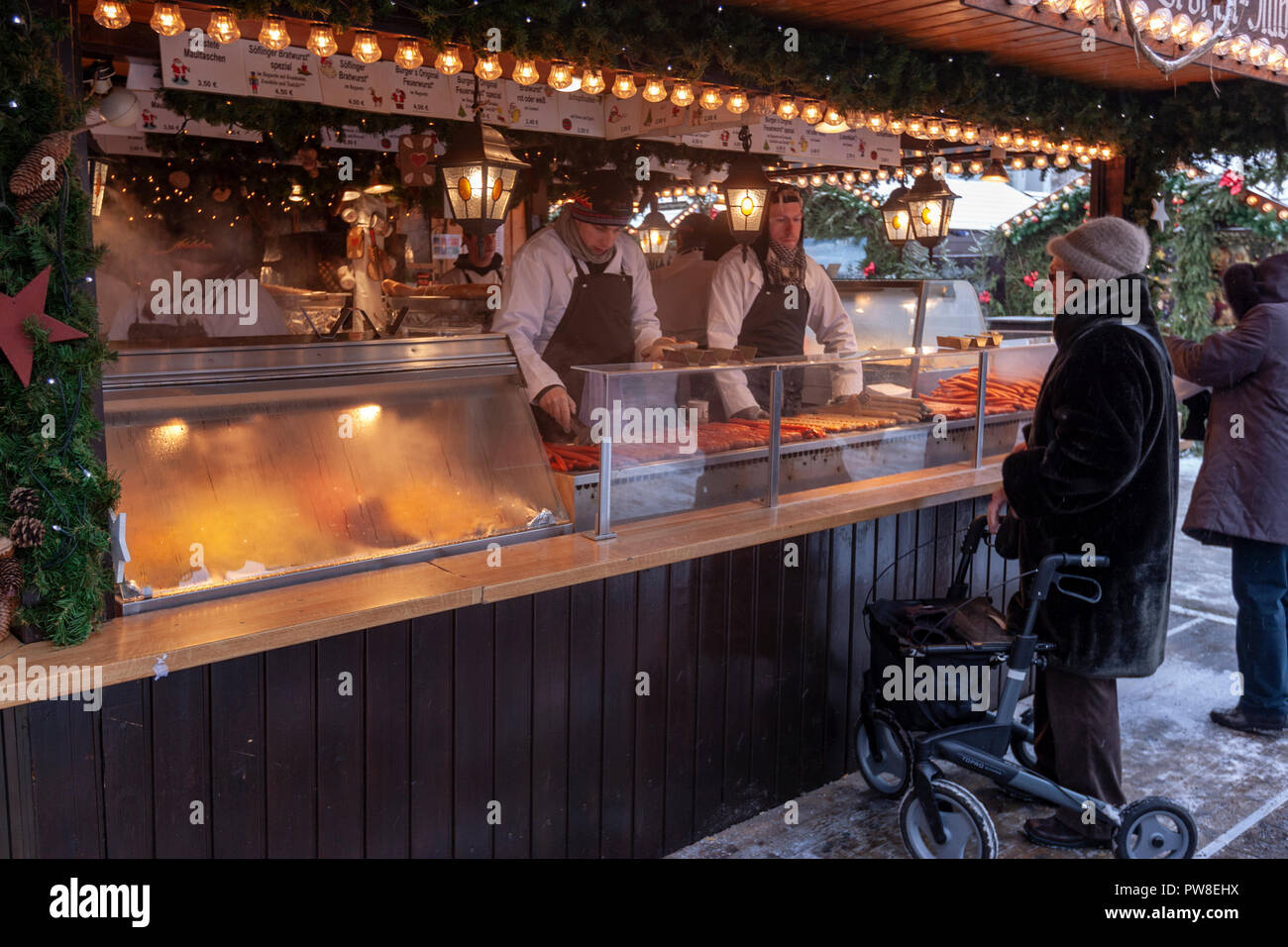 Woman buying a sausage, Wurst, in the Traditional German Christmas ...
