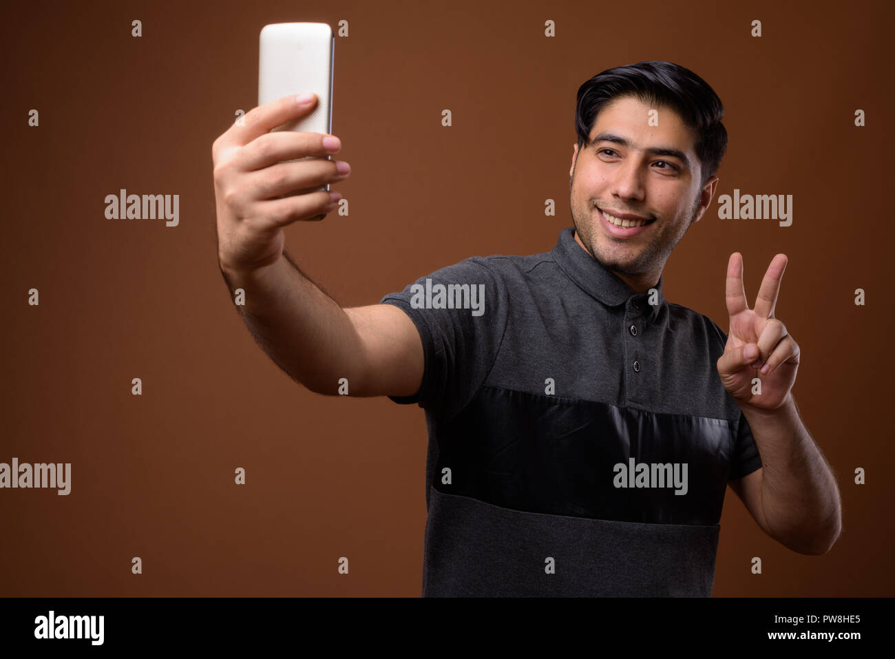 Happy handsome persian man using hi-res stock photography and images ...