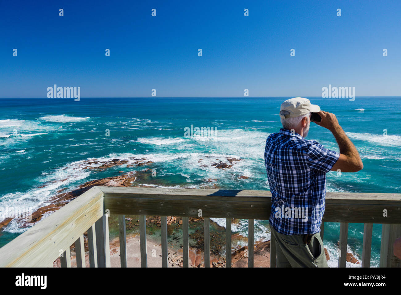 Man looking out to sea with binoculars on the viewing platform on the ...