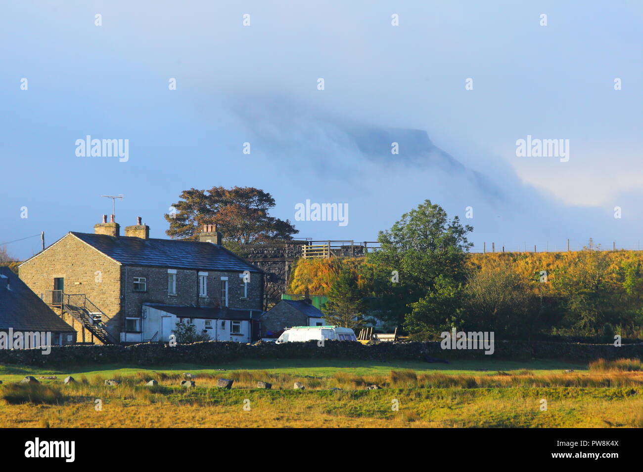 The Station Inn at the foot of Inlgeborough which is covered in a ...