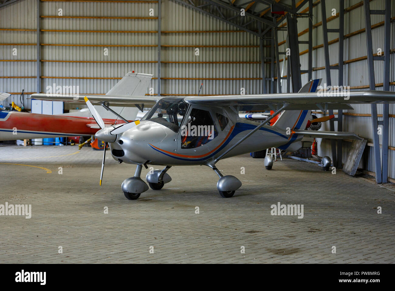 outdoor shot of small plane standing in shed Stock Photo - Alamy