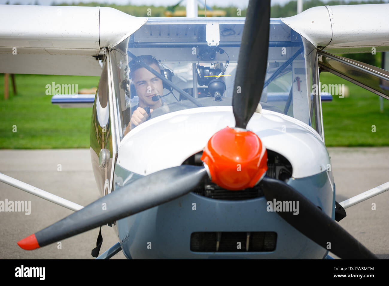 outdoor shot of young man in small plane cockpit Stock Photo - Alamy