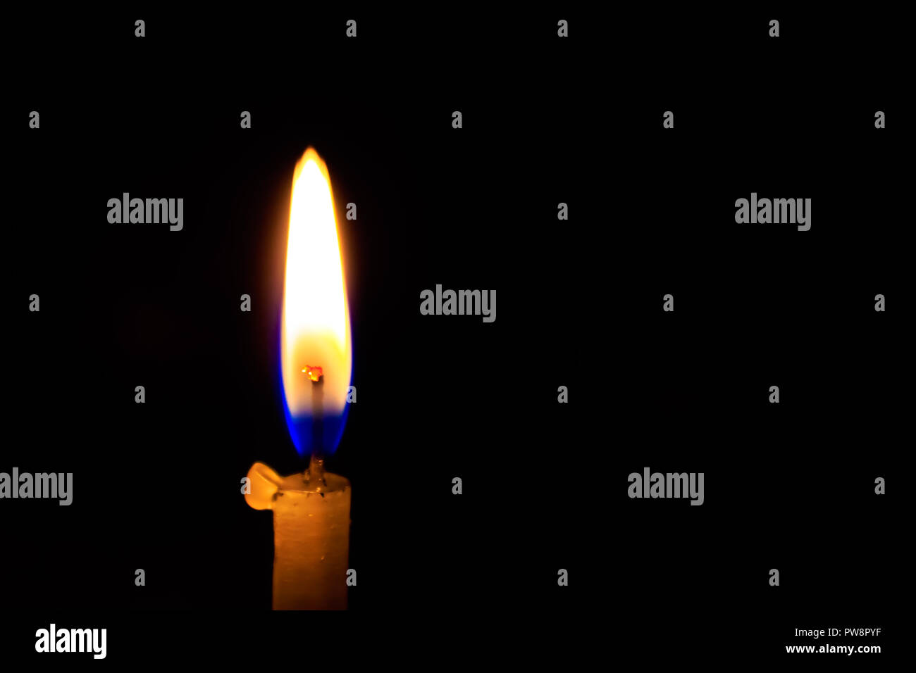 Candle spreading light isolated on blur background Stock Photo - Alamy