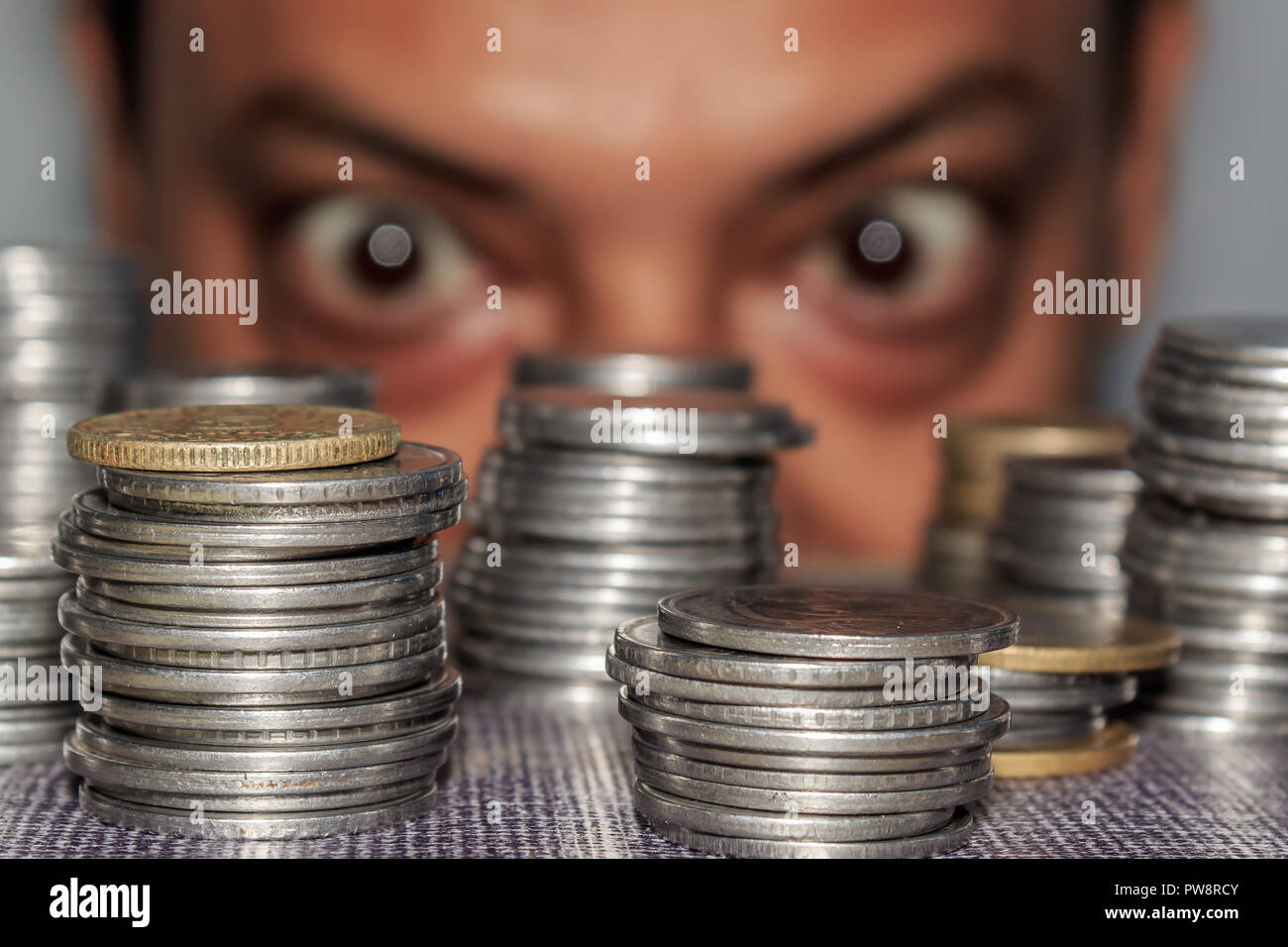 Focus on Coin. A rich greedy elderly man looks at coins. The collector ...