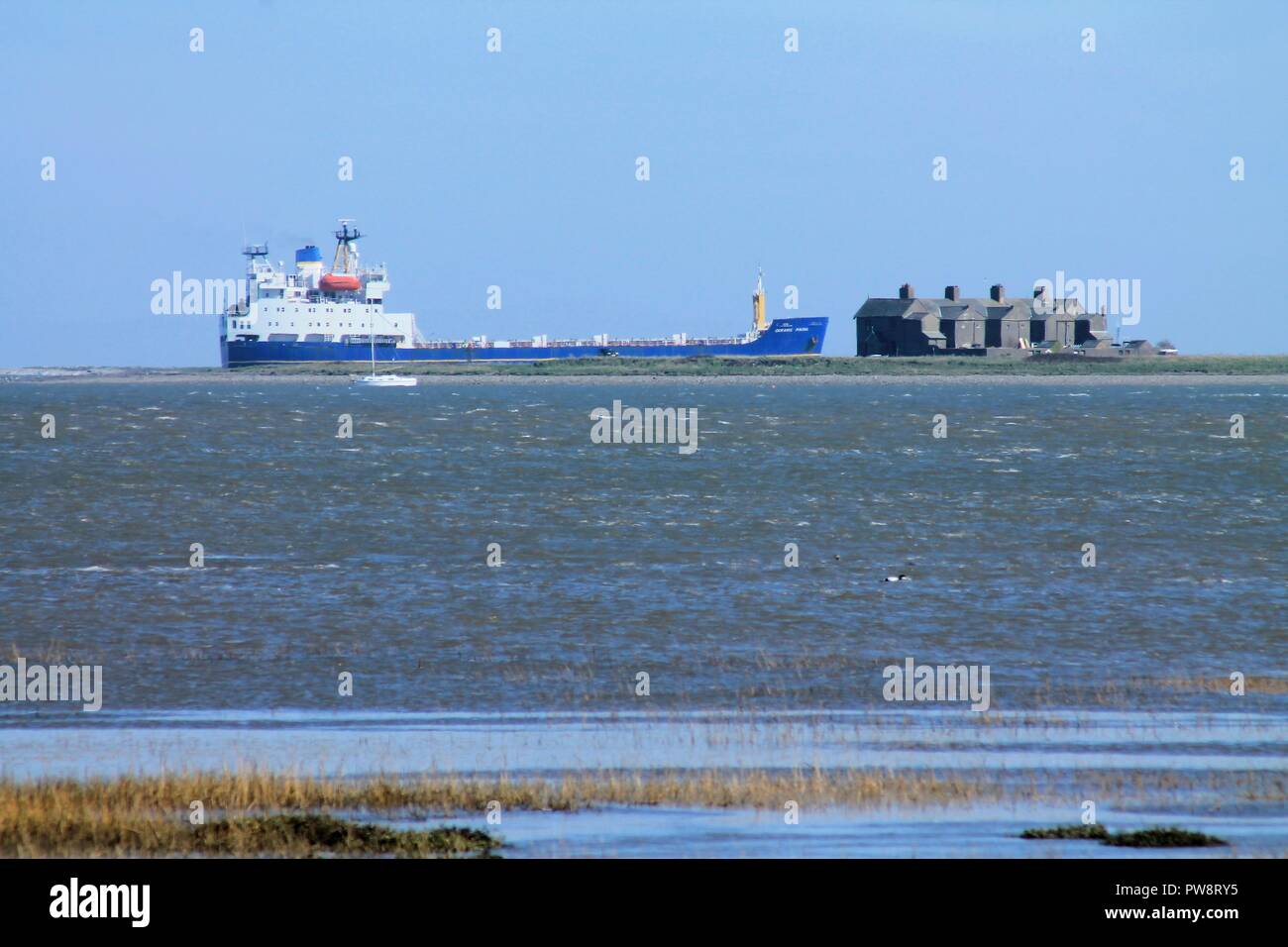 UK Cumbrian Coast. View towards Piel and Roa Island as a ship passes ...