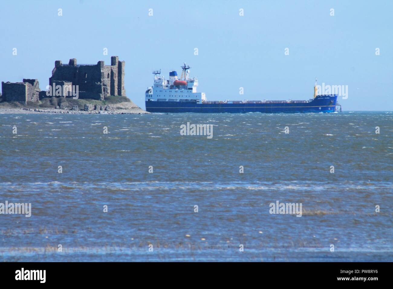 UK Cumbrian Coast. View towards Piel and Roa Island as a ship passes ...