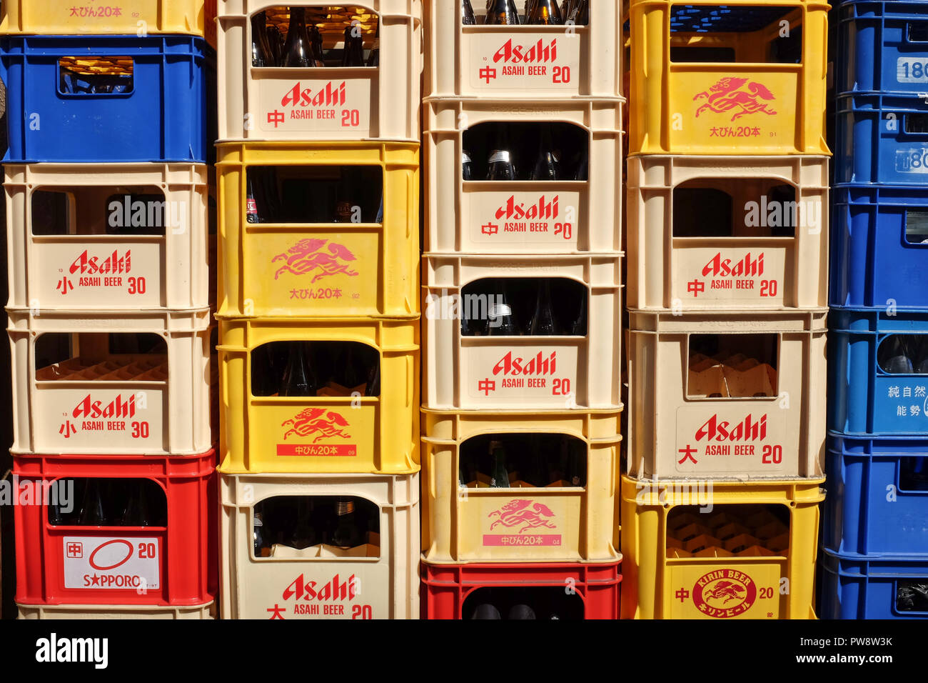 Beer crates for Japanese beers (Asahi, Kirin, and Sapporo) stacked up ...