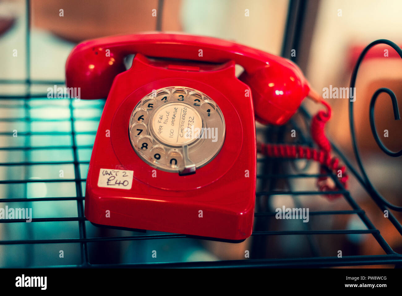 A bright red old telephone for sale at an antique store in Sheffield ...