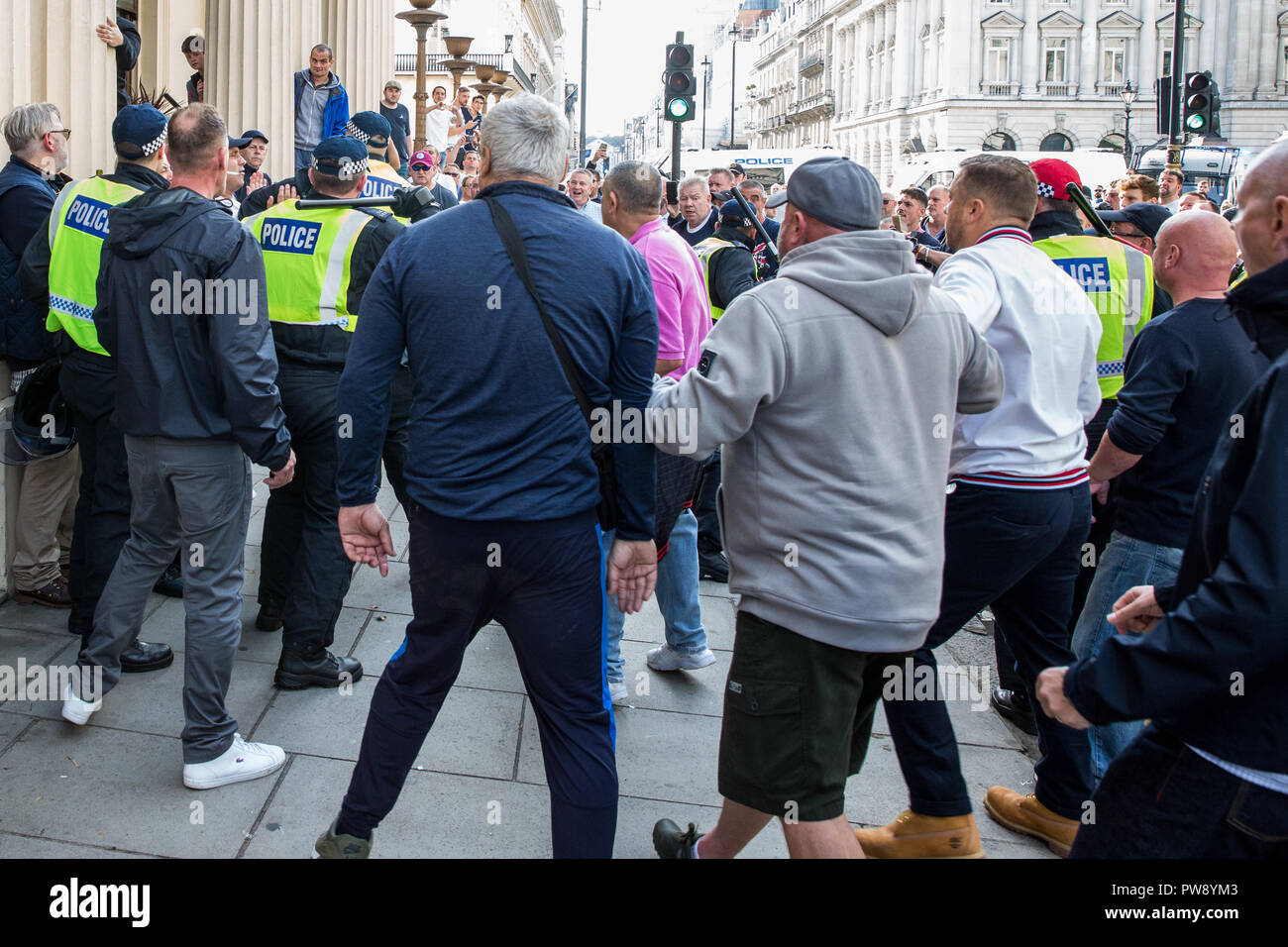 London, UK. 13th October, 2018. Police officers with raised batons ...