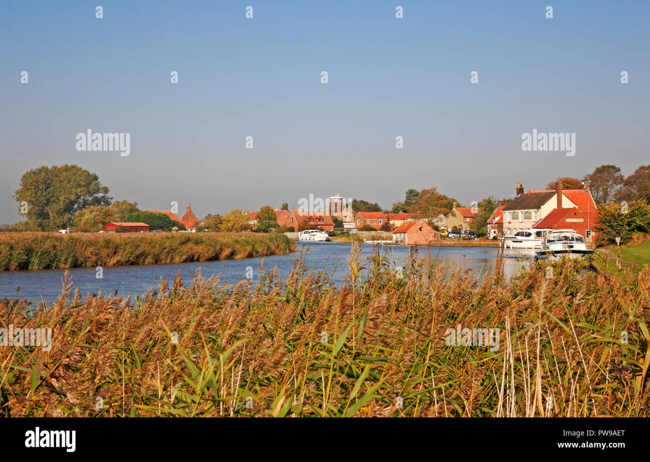 A view of the River Bure on the Norfolk Broads and the village of ...