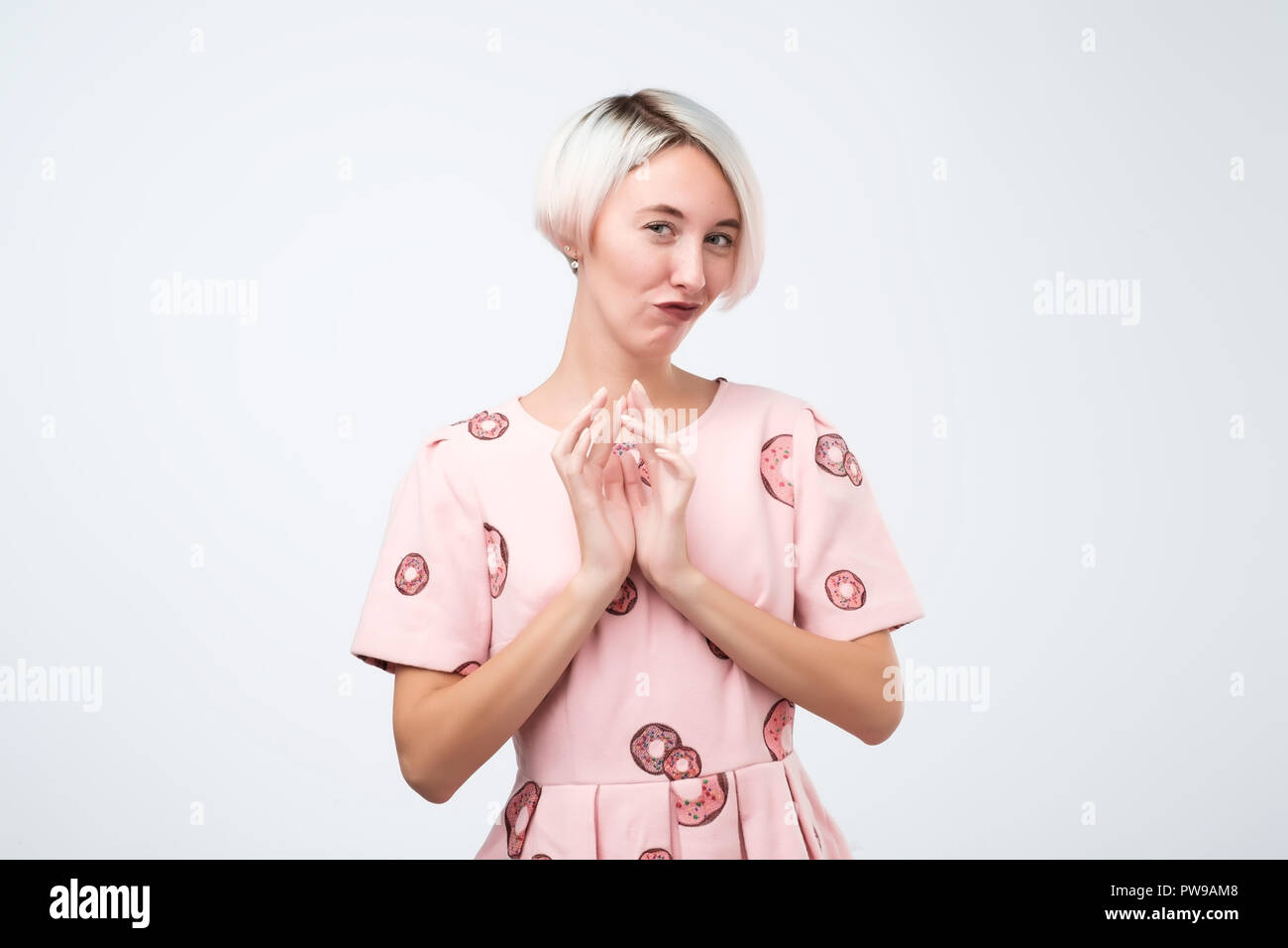Portrait of stunning young female looking away with sly cunning smile ...
