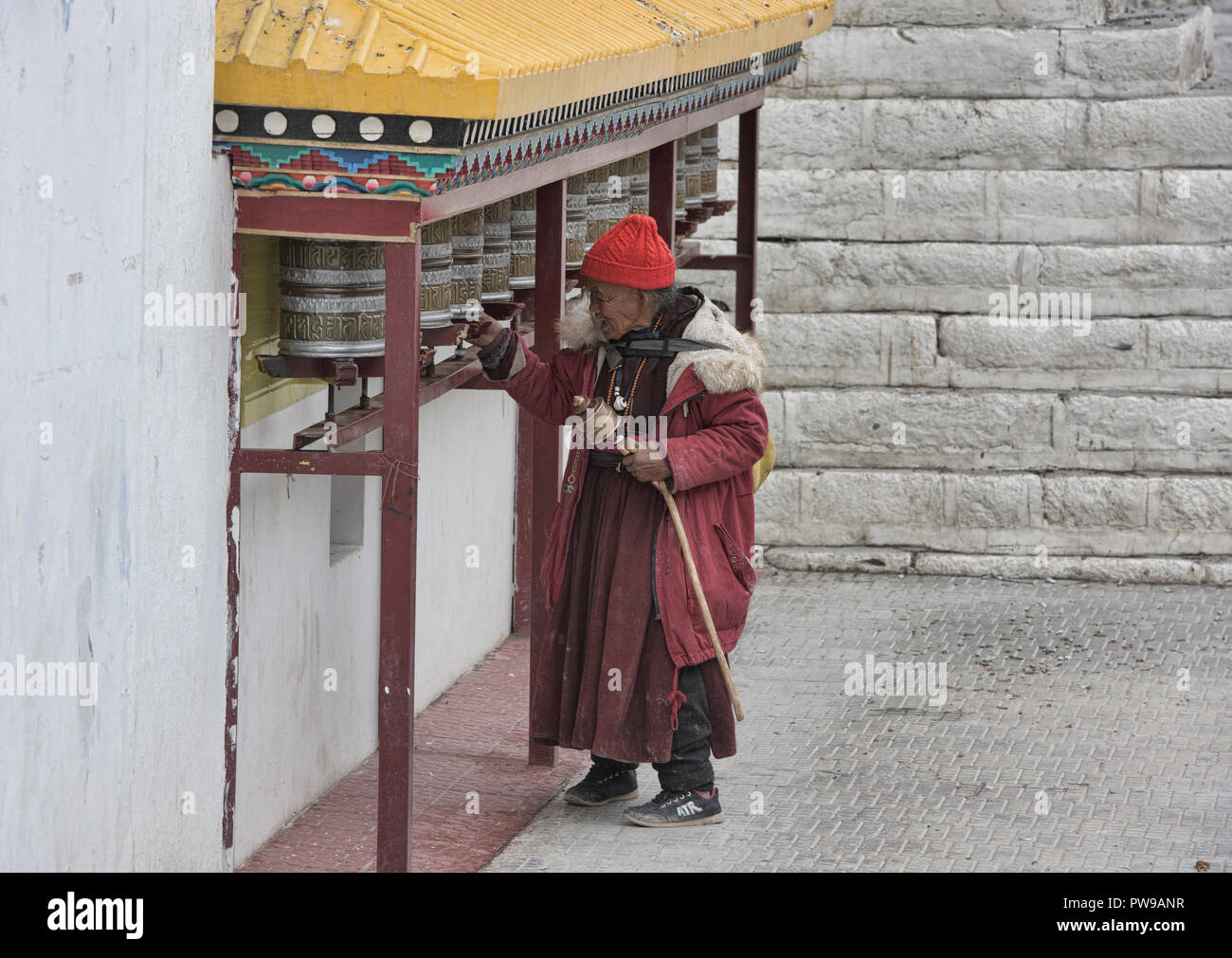 Old Ladakhi woman spinning prayer wheels, Leh, Ladakh, India Stock ...