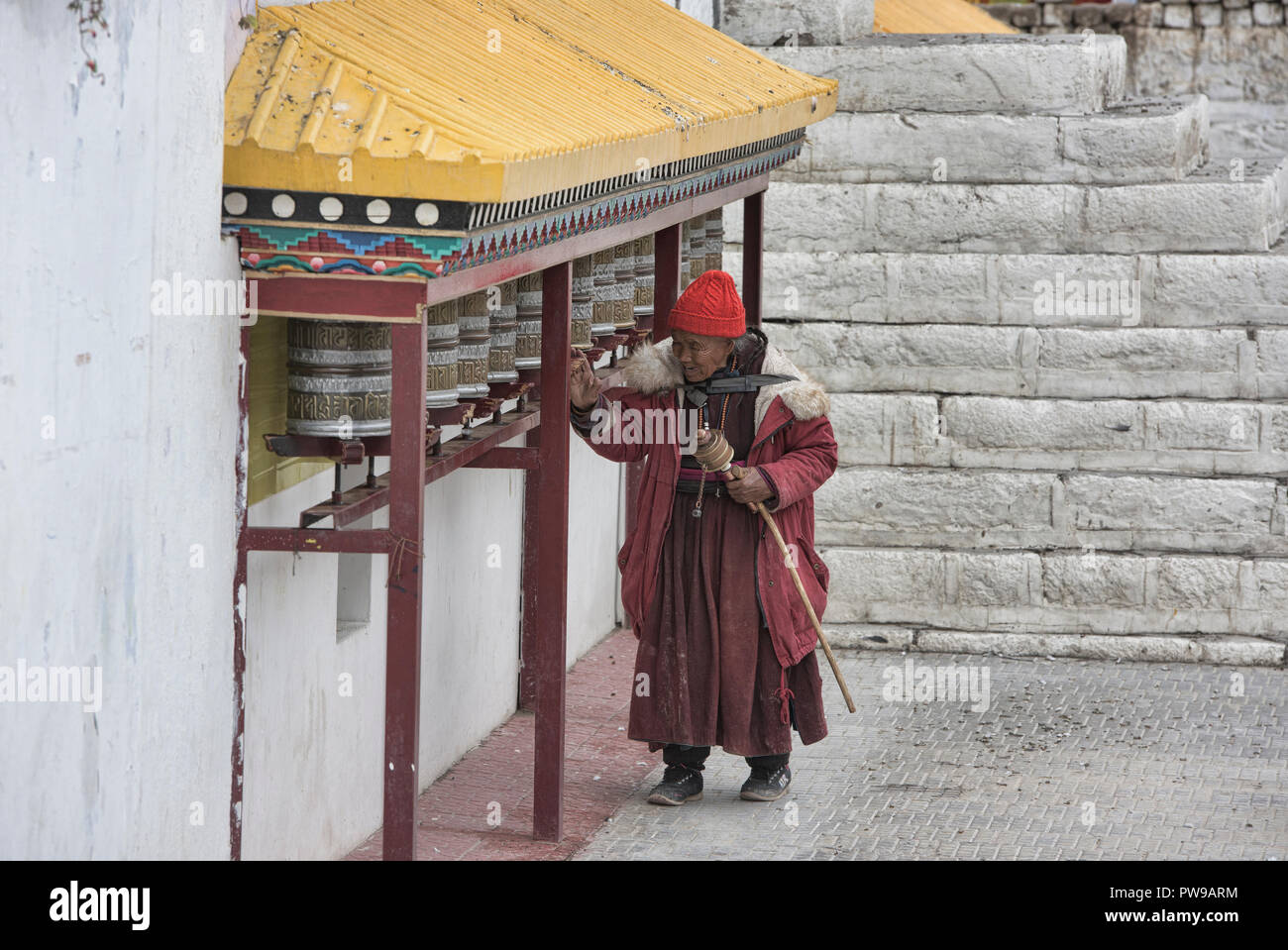 Tibetan woman spin prayer wheel hi-res stock photography and images - Alamy