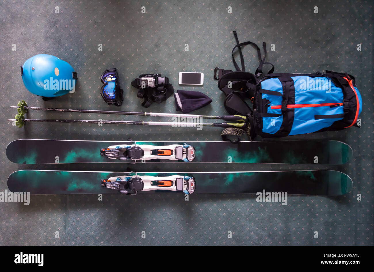 top view of ski accessories placed on floor. Items included helmet ...