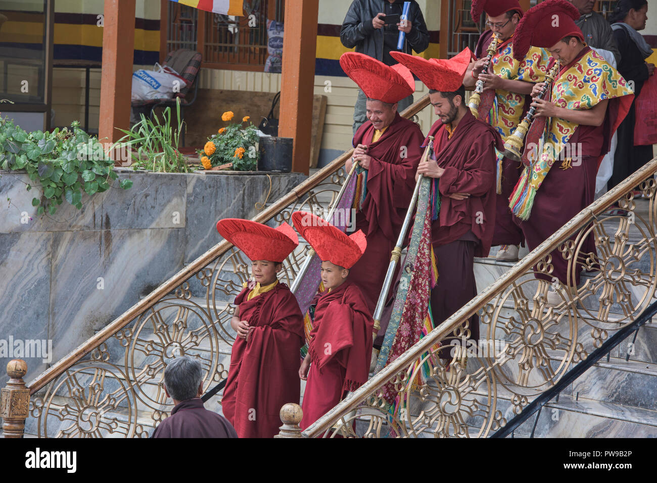 Red hat monks performing at a traditional Tibetan Buddhist Cham dance ...