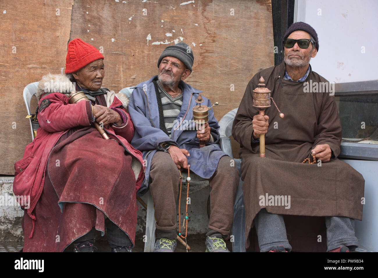 Old Ladakhi woman and men spinning prayer wheels, Leh, Ladakh, India ...