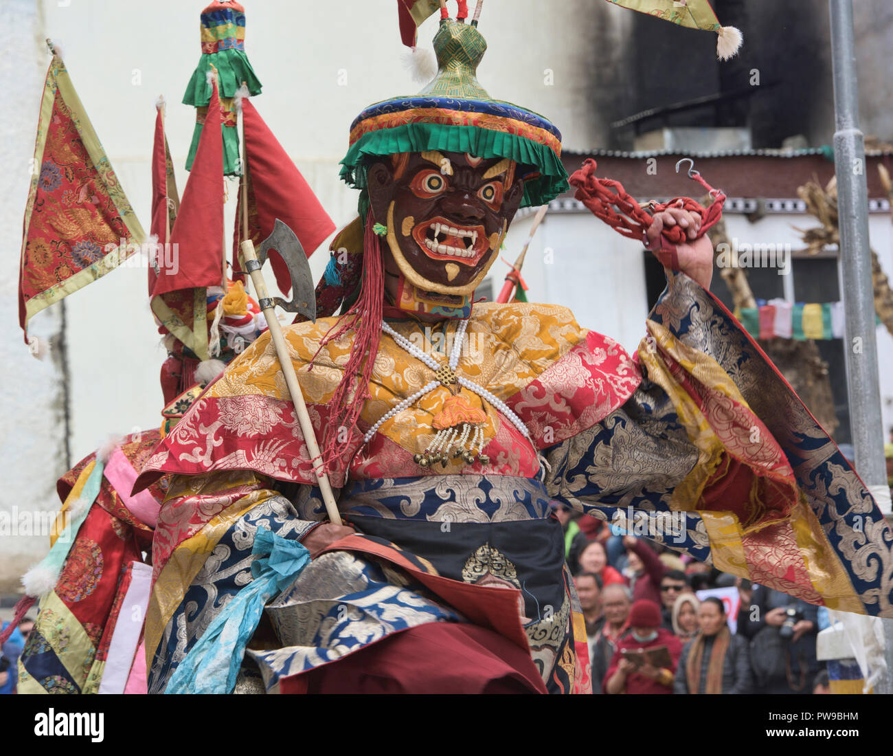 A masked monk performing at a traditional Tibetan Buddhist Cham dance ...