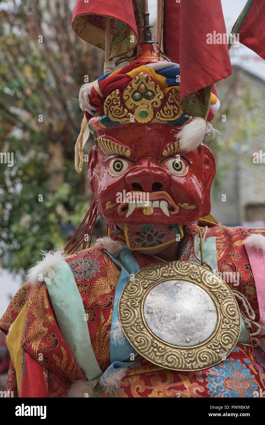 A masked monk performing at a traditional Tibetan Buddhist Cham dance ...