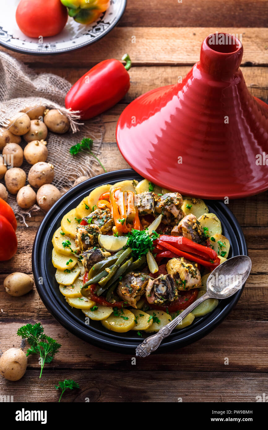 Moroccan fish tajine with chermoula, red peppers and potato Stock Photo ...