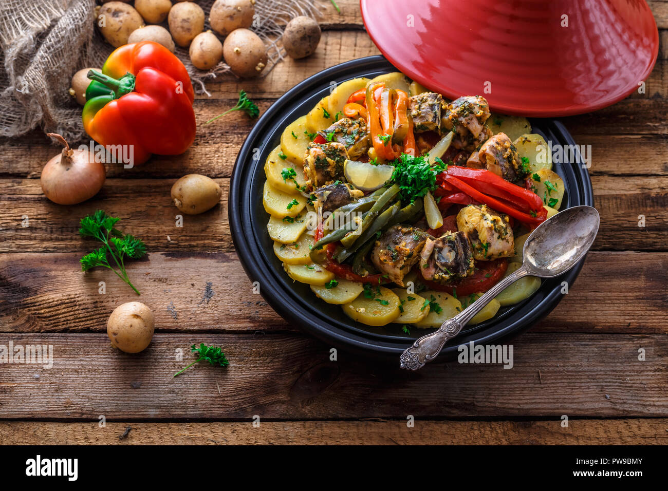 Moroccan fish tagine with chermoula, red peppers and potato Stock Photo ...