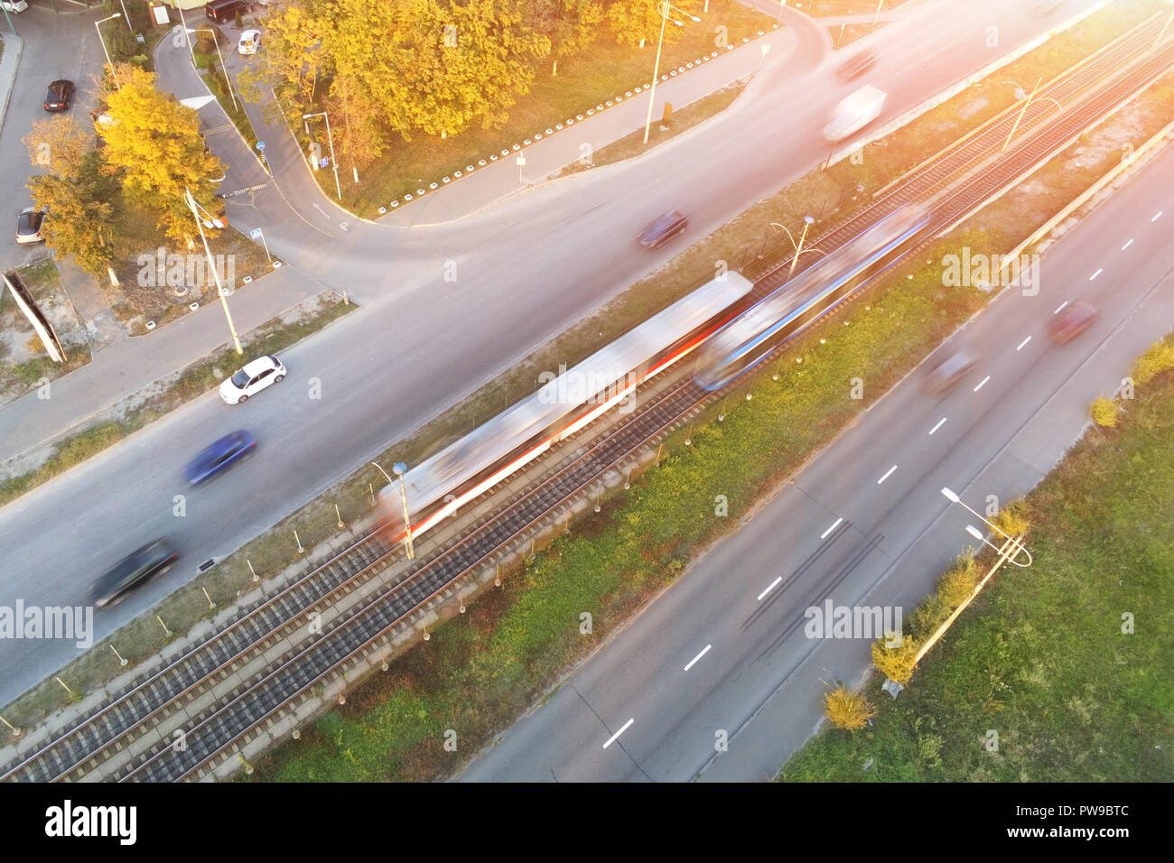Public transport on city street. Trams aerial view moving fast between ...
