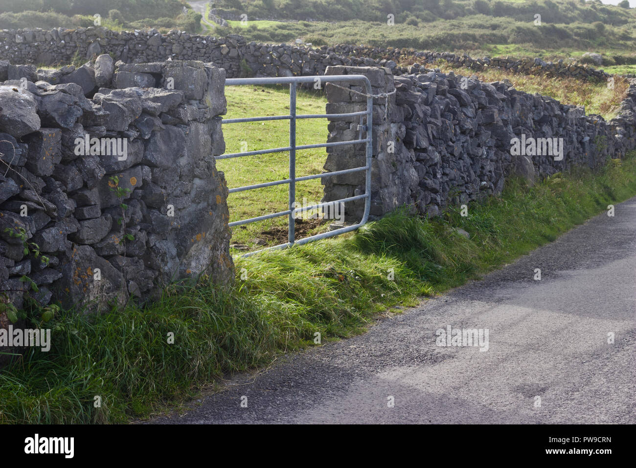 Close up view of a steel metal gate connected to a stone wall in a ...