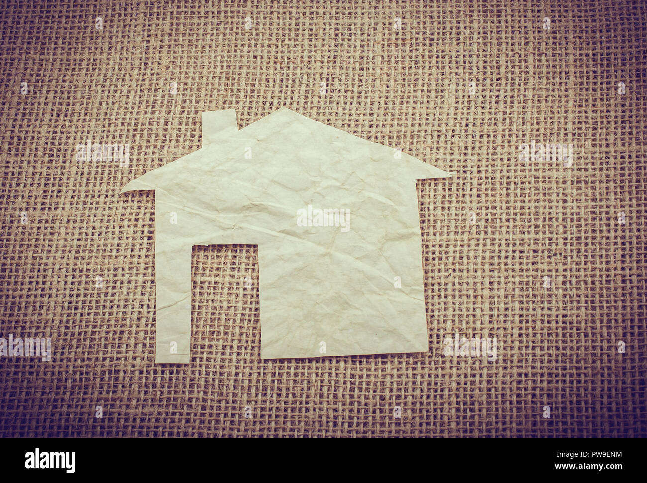 Little house shape cut out of paper on a canvas background Stock Photo ...