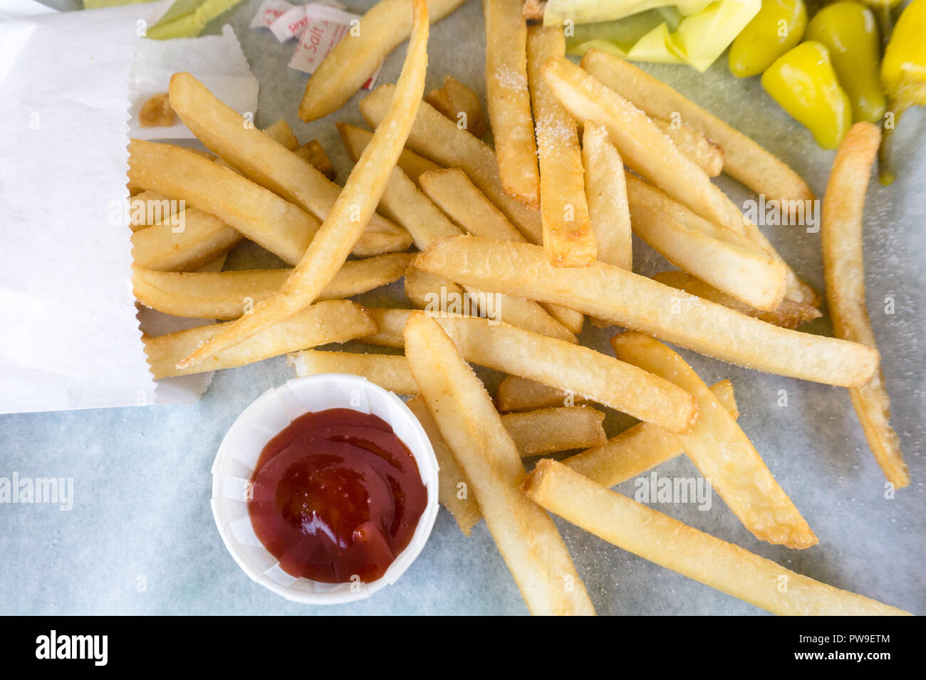 Close up of delicous greasy junk food french fries at fast food stand ...