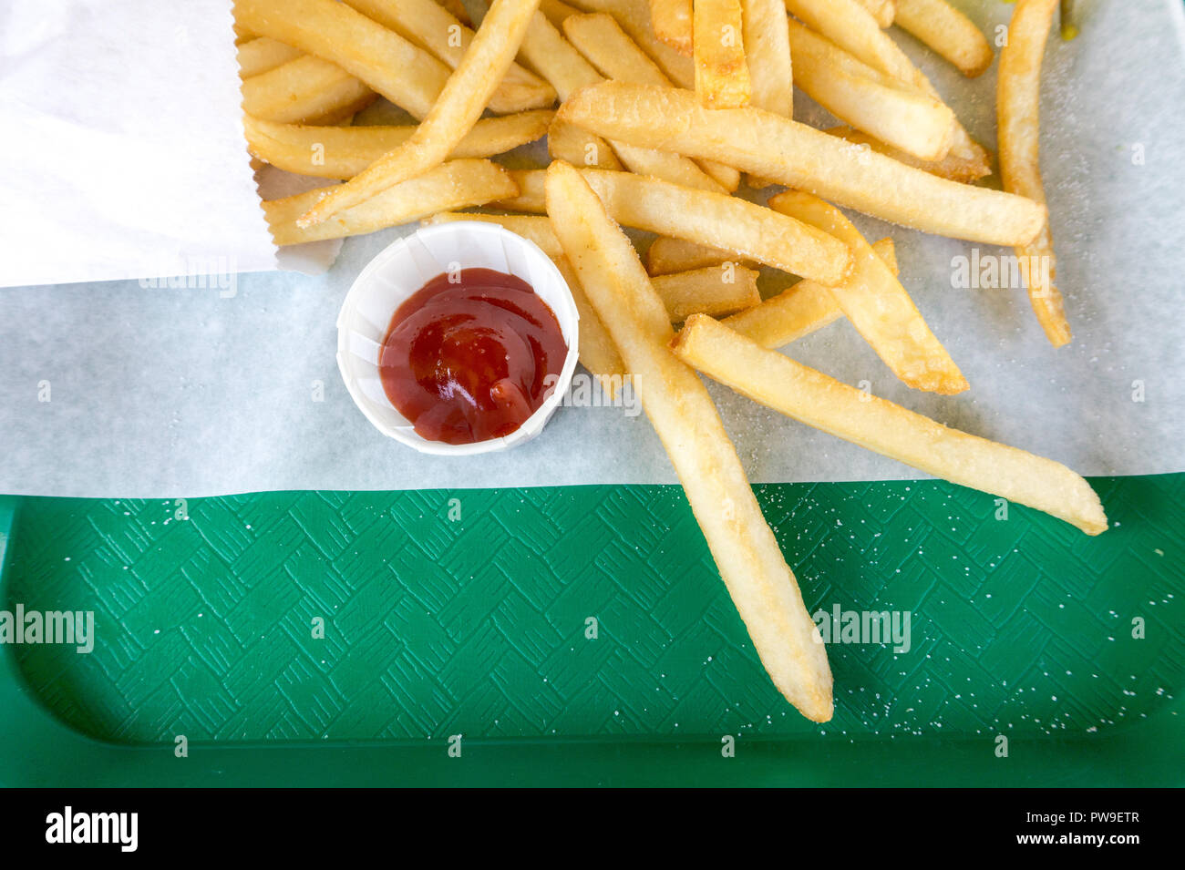 Close up of delicous greasy junk food french fries at fast food stand ...