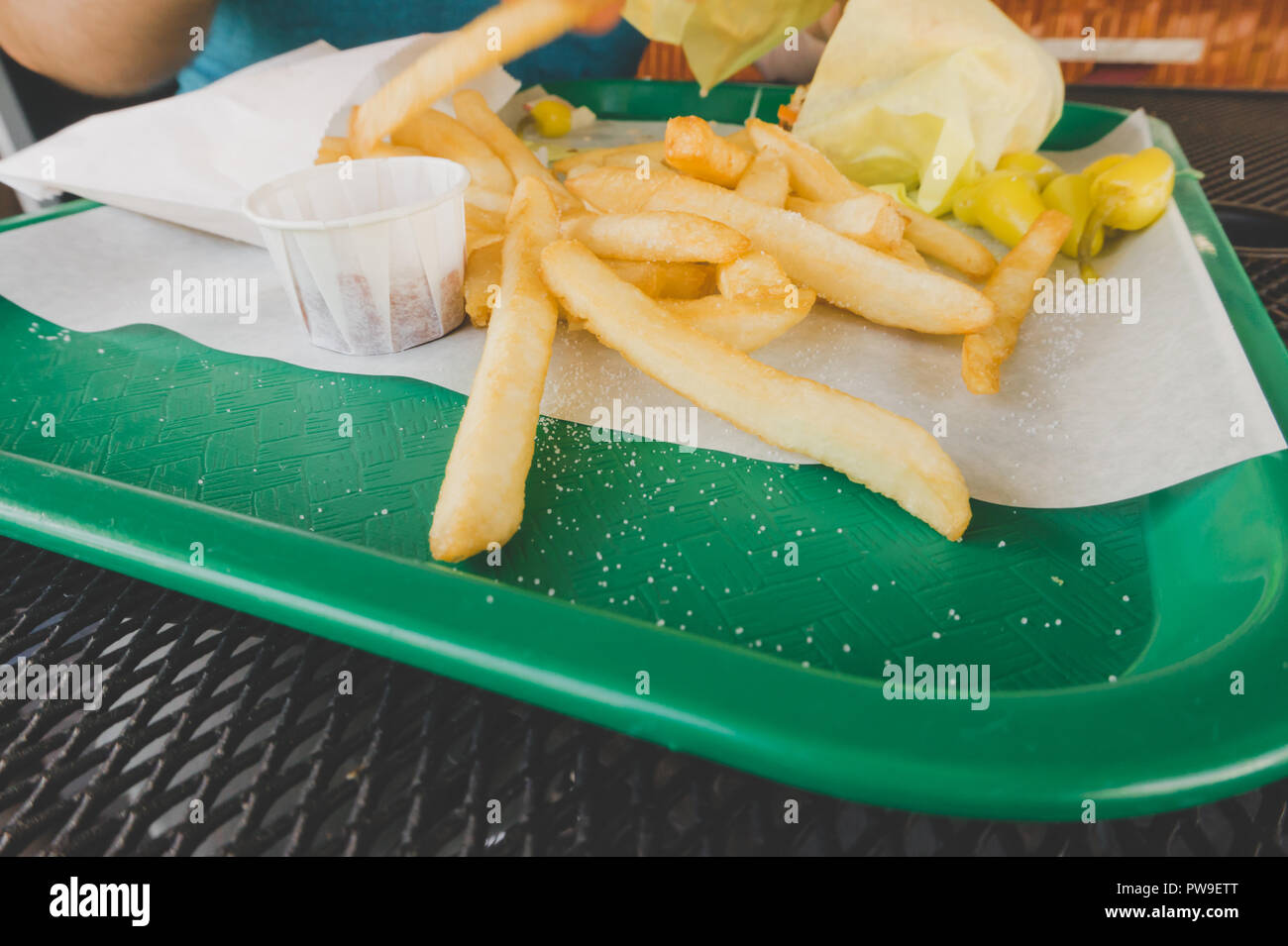 Close up of delicous greasy junk food french fries at fast food stand ...