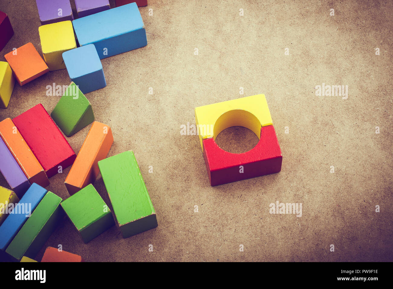 Colorful building blocks on a brown background Stock Photo - Alamy