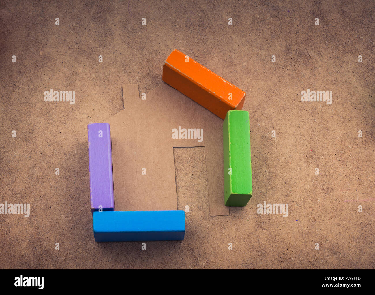 House shape formed out of building blocks on a brown background Stock ...