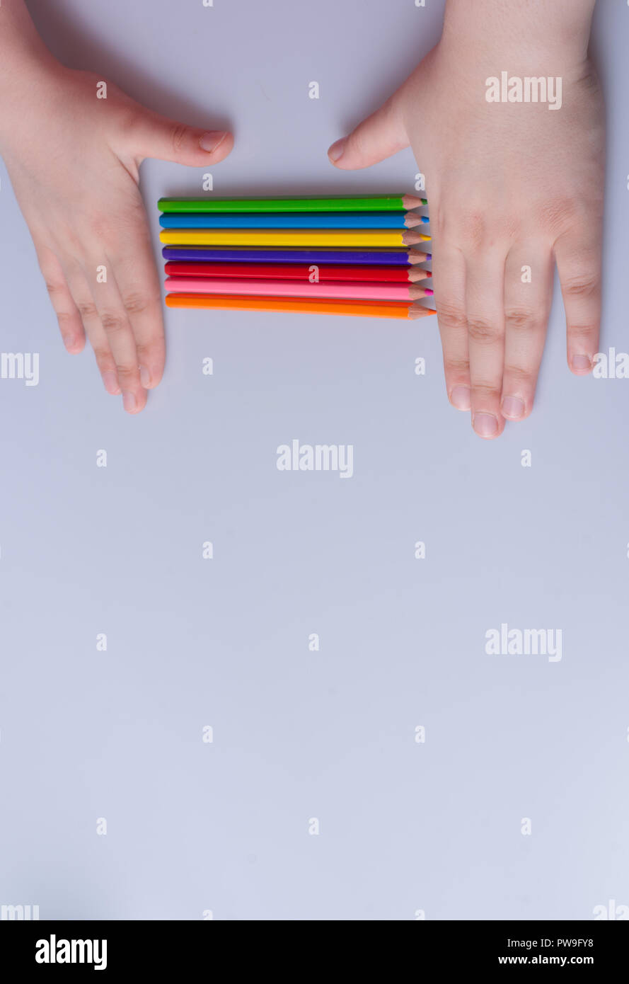 Hand holding color Pencils placed on a white background Stock Photo - Alamy