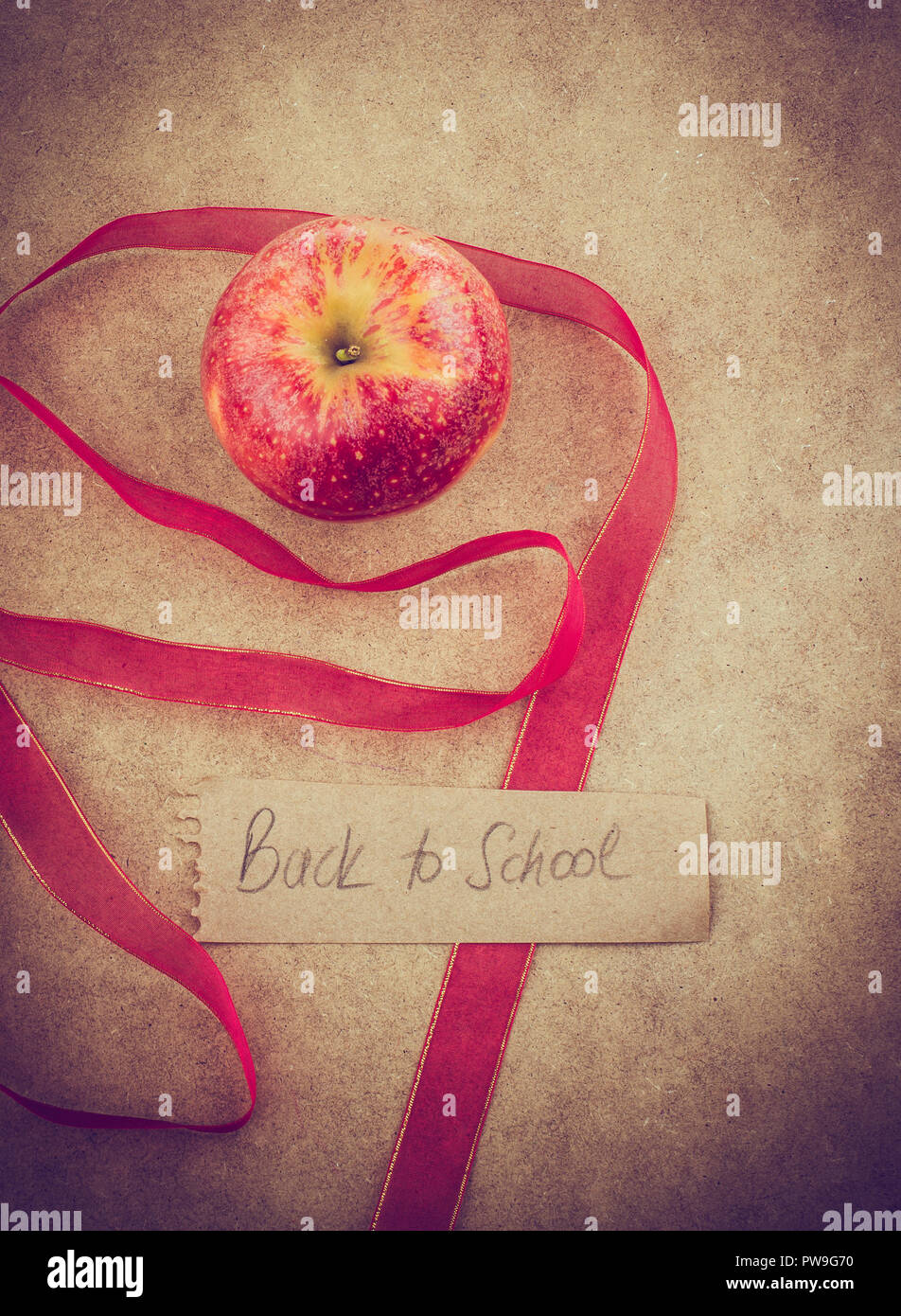 Back to school lettering with apple and a red ribbon Stock Photo - Alamy