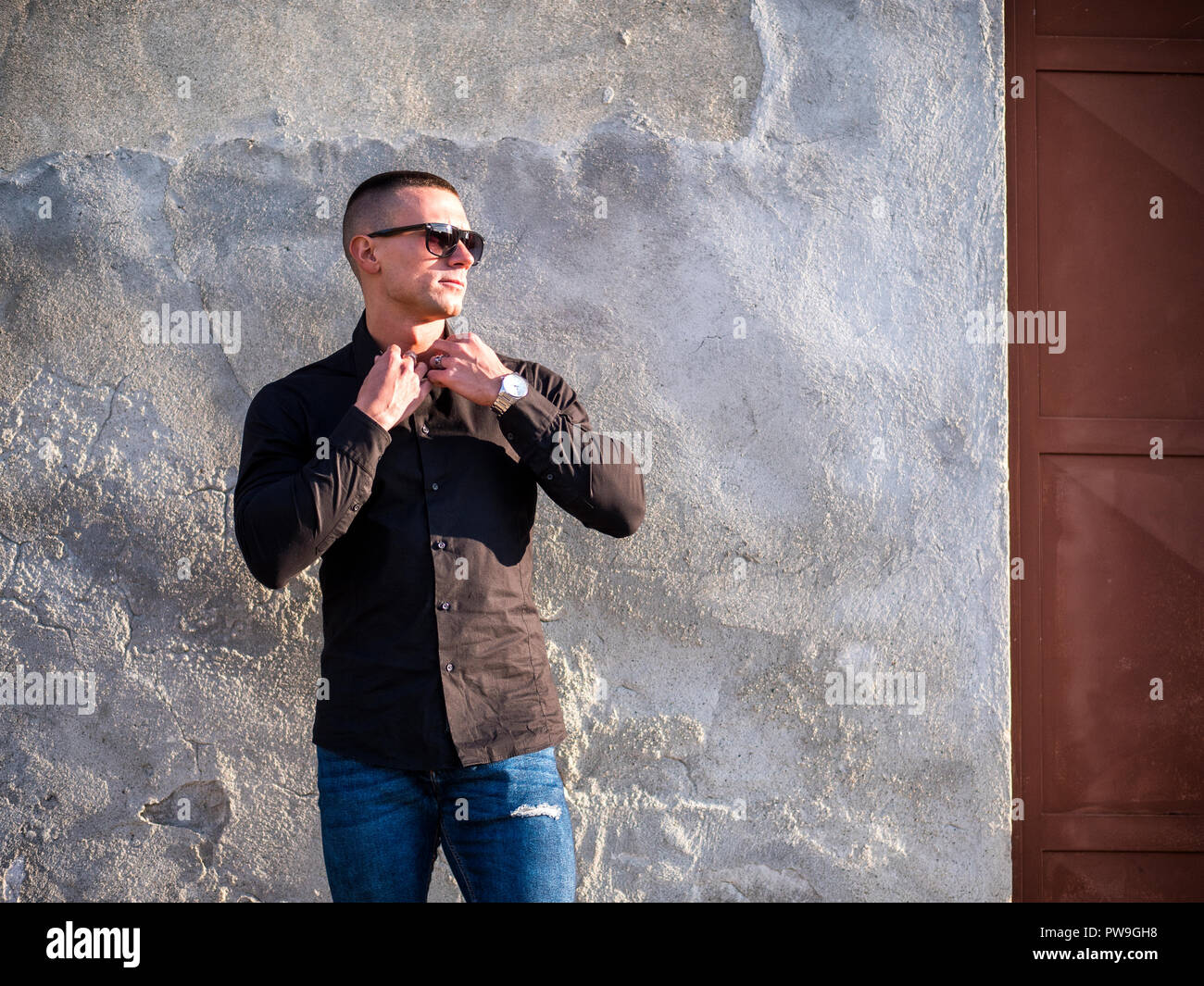 One handsome young man in city setting Stock Photo - Alamy