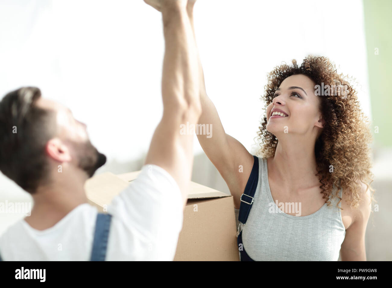 Happy and young couple giving a high five Stock Photo - Alamy