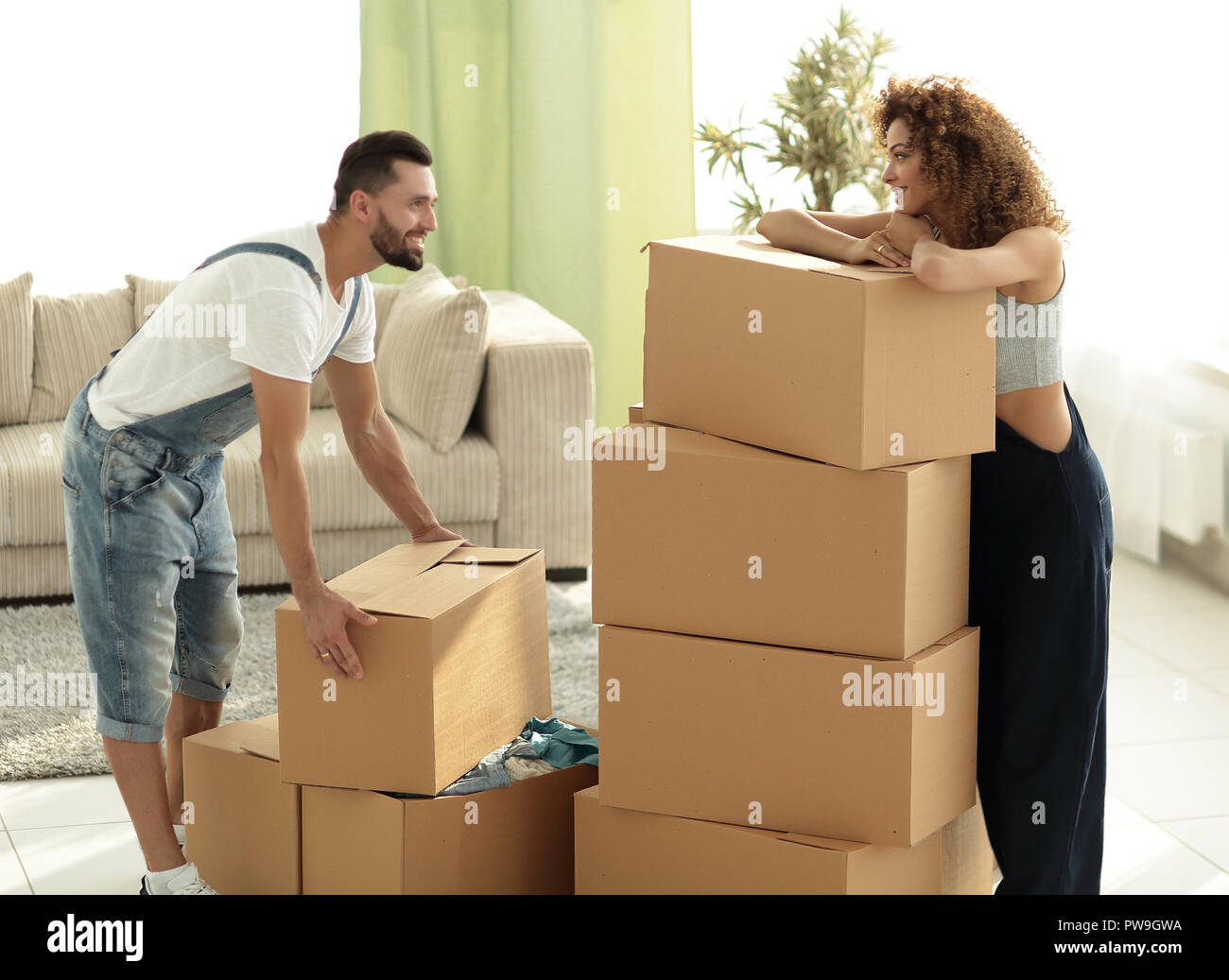 Happy and young couple looking at boxes Stock Photo - Alamy