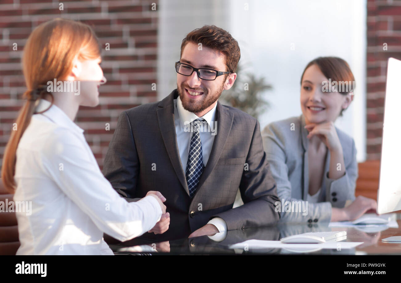 friendly handshake between colleagues in the office Stock Photo - Alamy