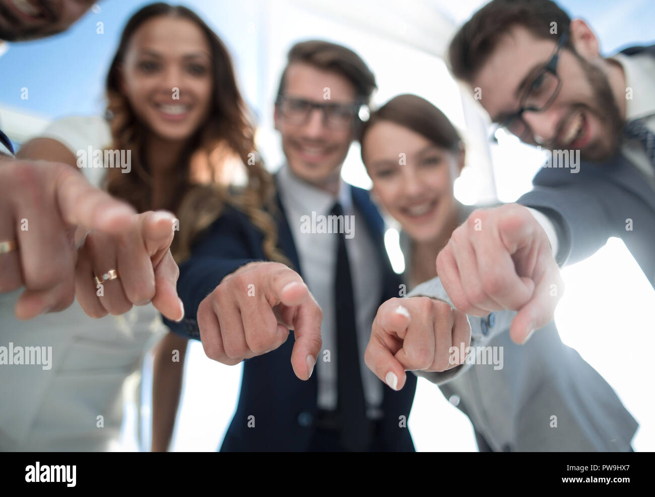 close up.smiling business team pointing at you Stock Photo - Alamy