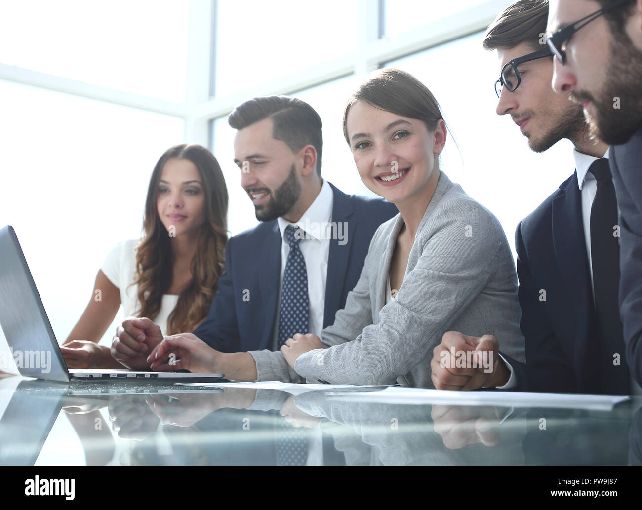 business team sitting at the office Desk in the office Stock Photo - Alamy